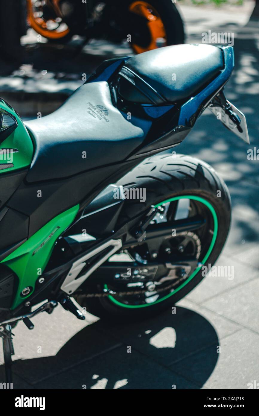 Biker on Motorcycle in the city beside barber shop and buildings Stock ...