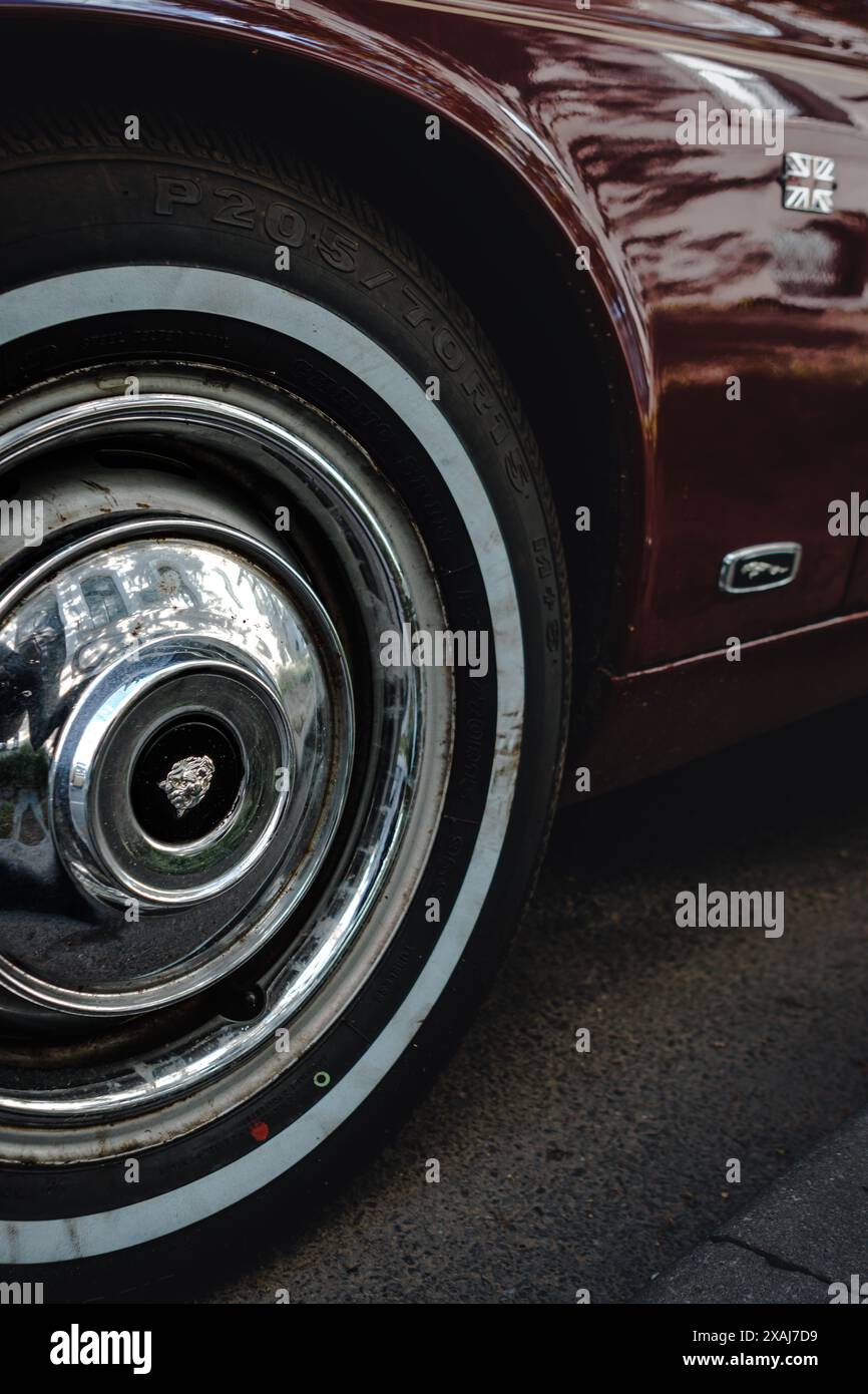 Red old car Jaguar on road in town between buildings Stock Photo - Alamy