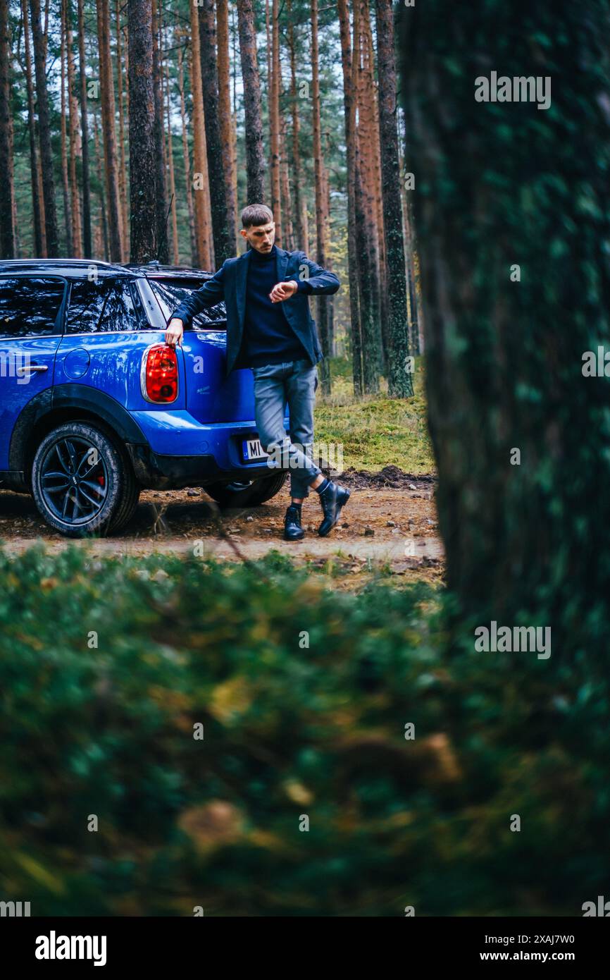Men with blue Mini Cooper country men and blue umbrella on cloudy day ...