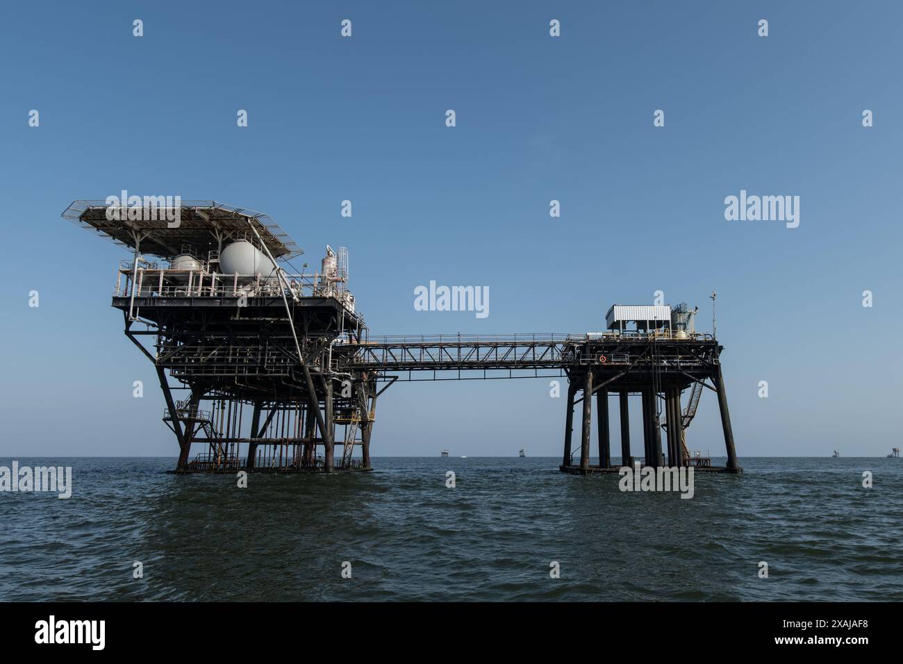 An offshore oil rig near Venice, Louisiana, stands tall in the Gulf of ...