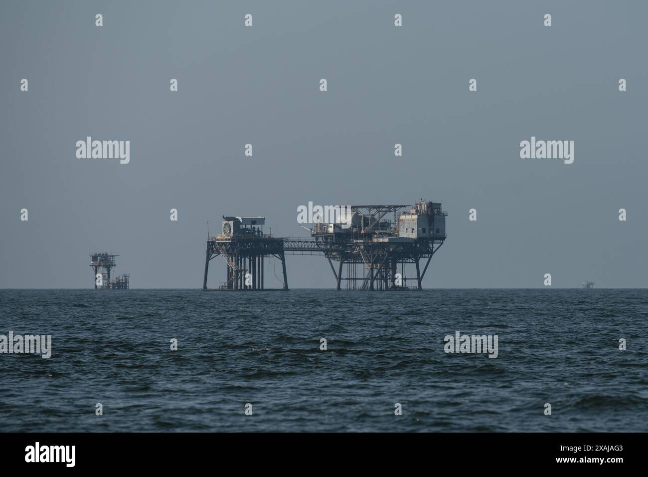 An offshore oil rig near Venice, Louisiana, stands tall in the Gulf of ...