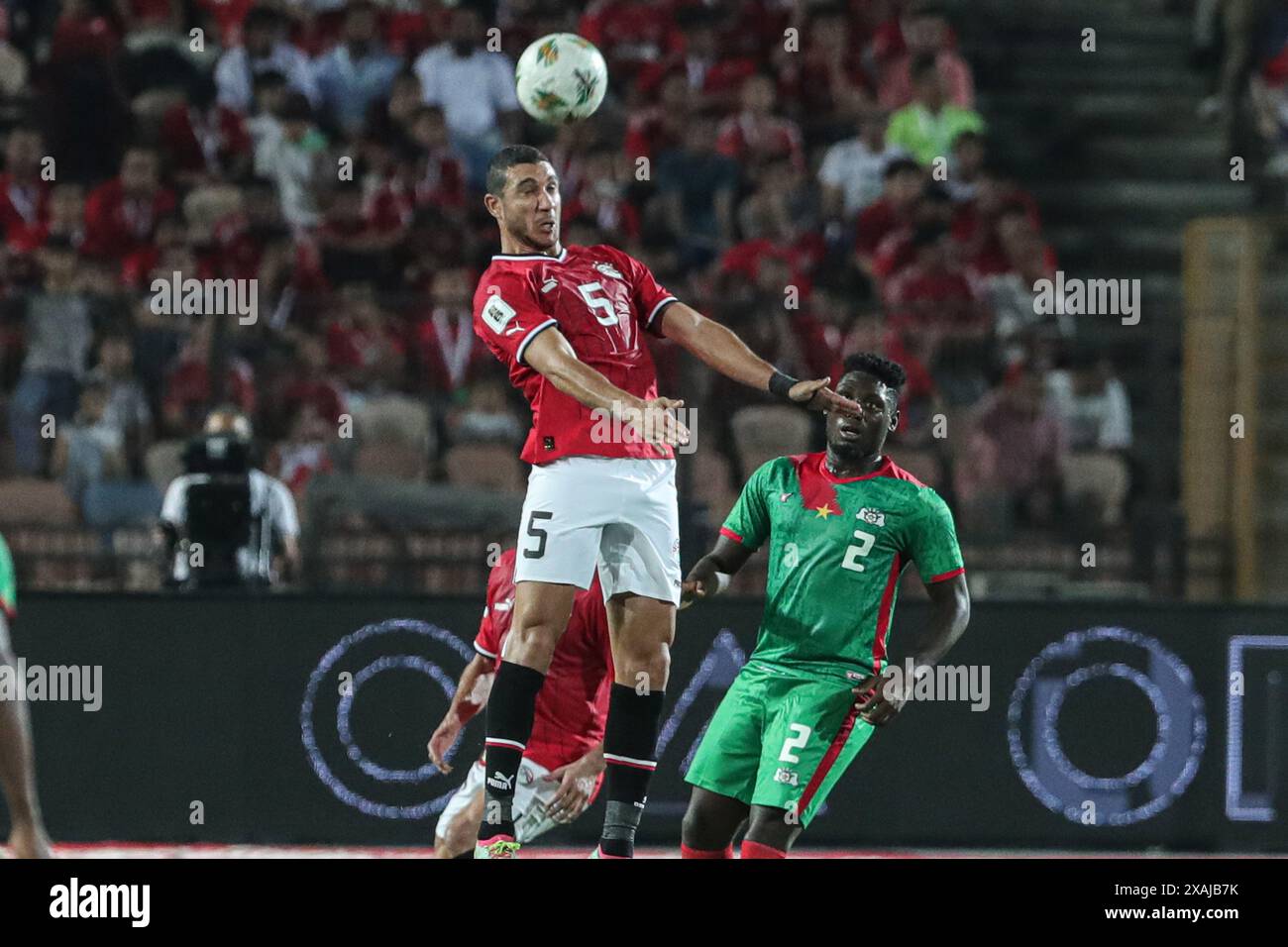 Cairo, Egypt. 6th June, 2024. Ramy Rabia (top) of Egypt heads the ball during the 2026 World Cup ...
