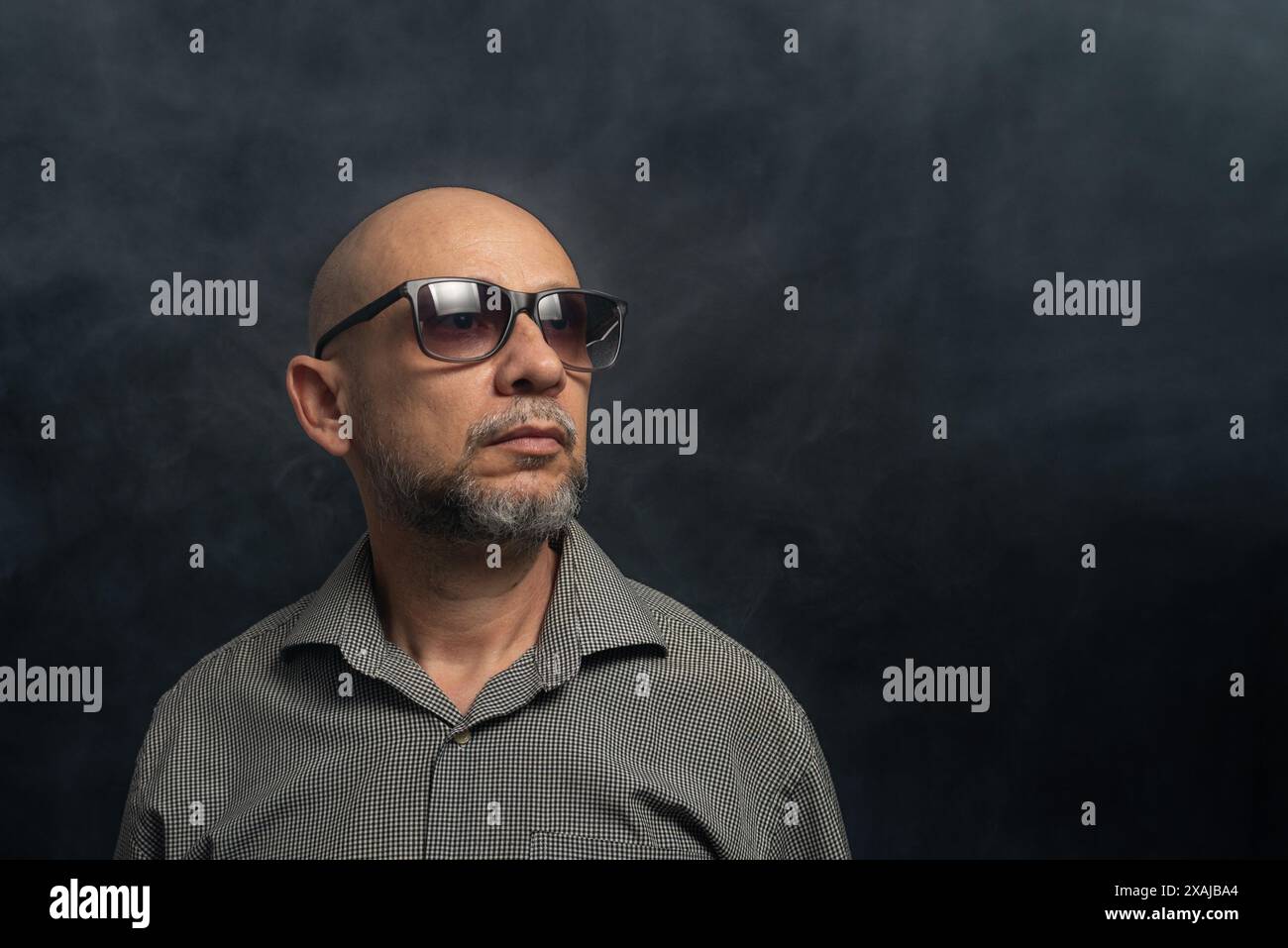 Bald middle-aged man posing for the camera. Isolated on studio ...