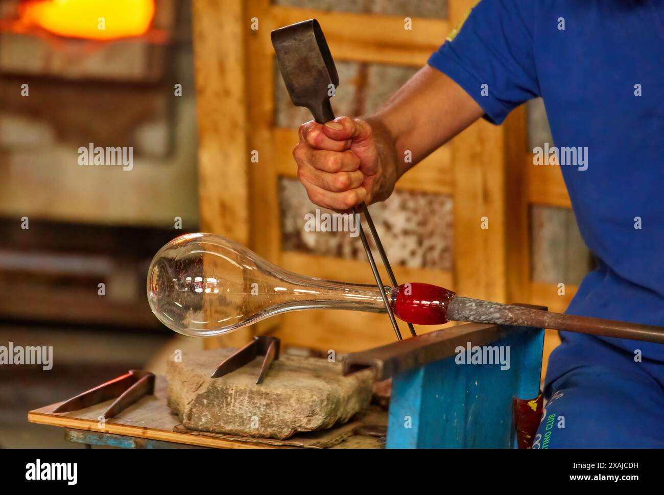 A Glass Blower Shaping Molten Glass into a Piece of Art Stock Photo - Alamy