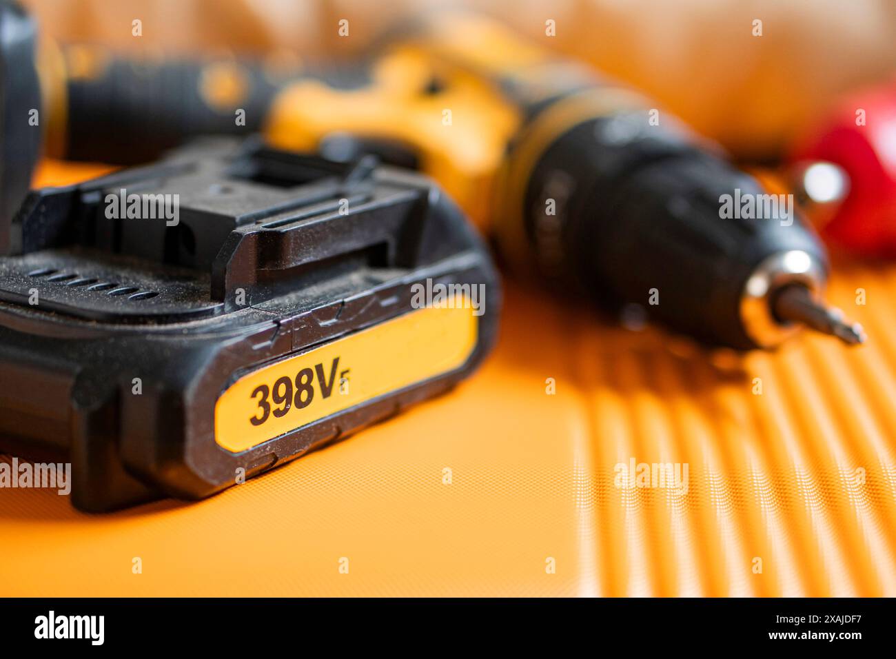 Close-up of a yellow and black cordless power drill with a screwdriver ...