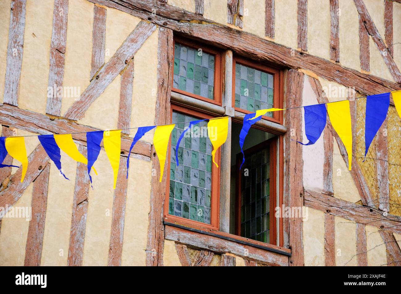 Street decorated with yellow blue flags garland for medieval festival ...