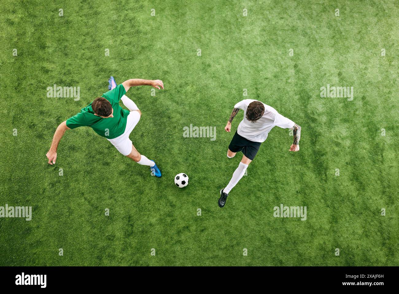 Aerial view. Two soccer players in attack position, fight for ball in ...