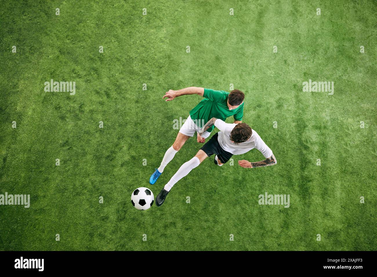 Aerial view. Two male soccer players in attacking position fight for ...