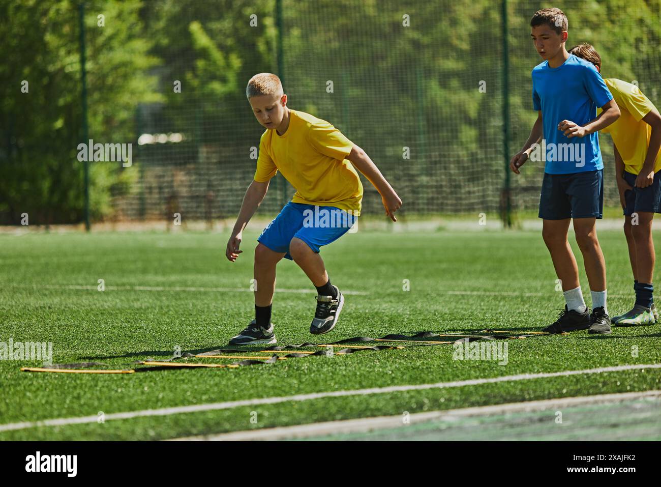 Focused Footwork Training. : Children in uniform training outdoors on ...