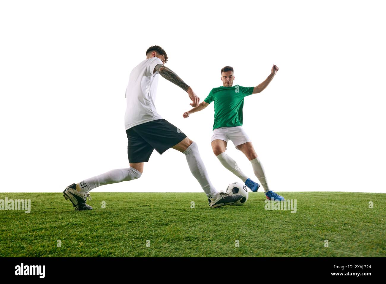 Two soccer players locked in struggle for ball on green lash playground ...