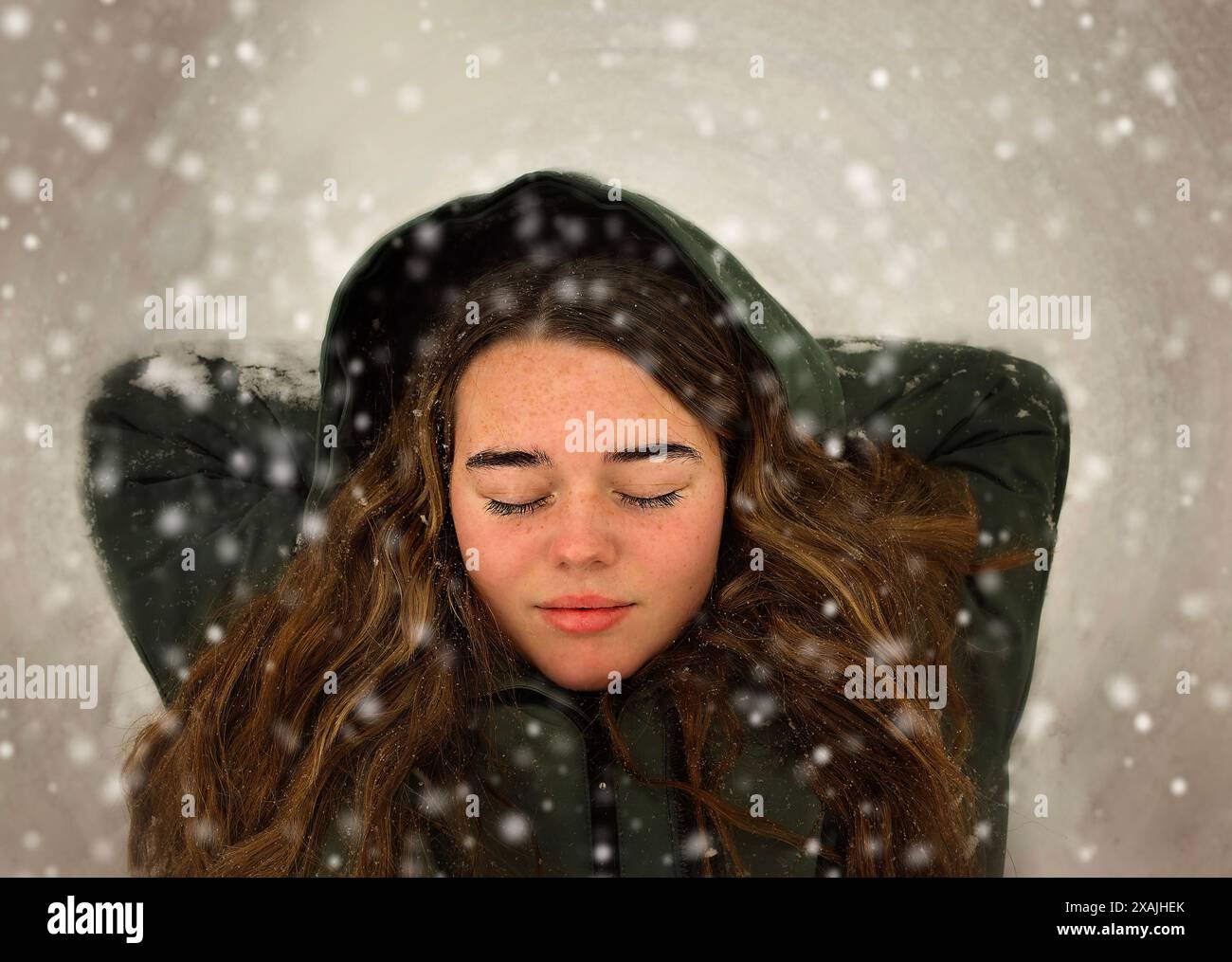 Beautiful teen girl laying with closed eyes in falling snow Stock Photo ...