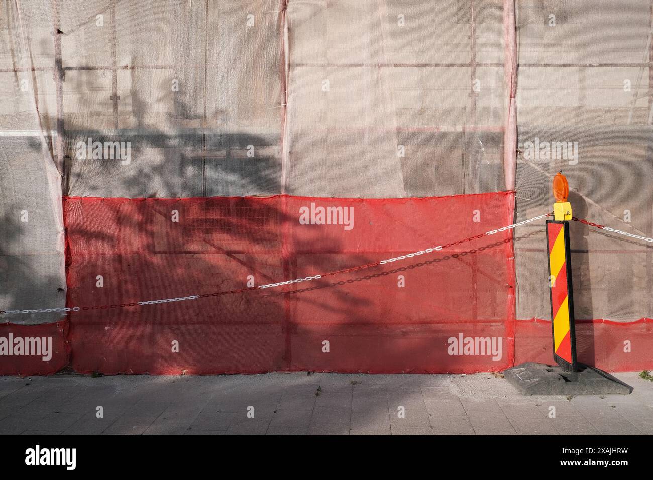 Plastic sheeting for scaffolding covering a facade under renovation, a ...
