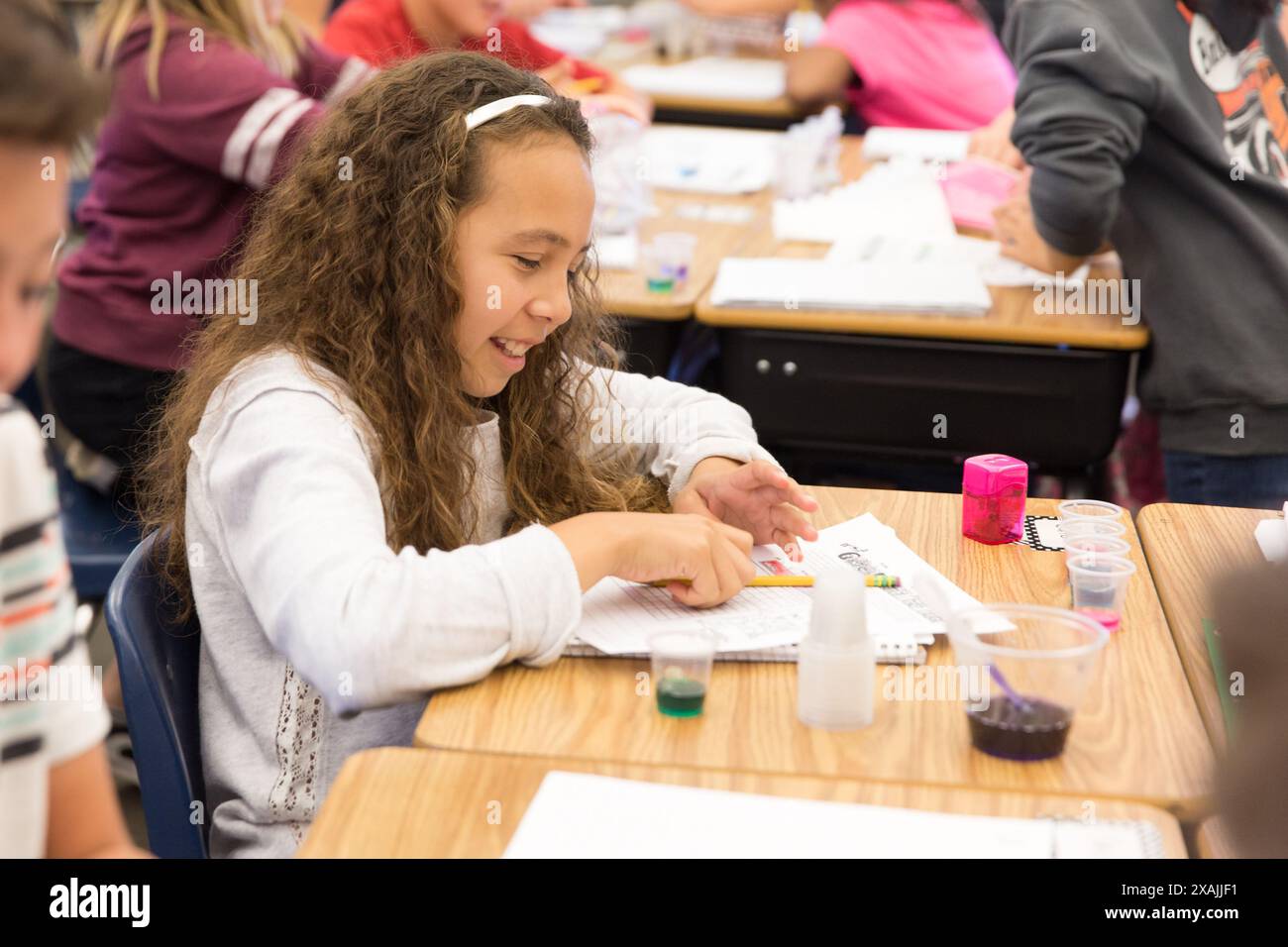 Happy student engaging in science class Stock Photo - Alamy
