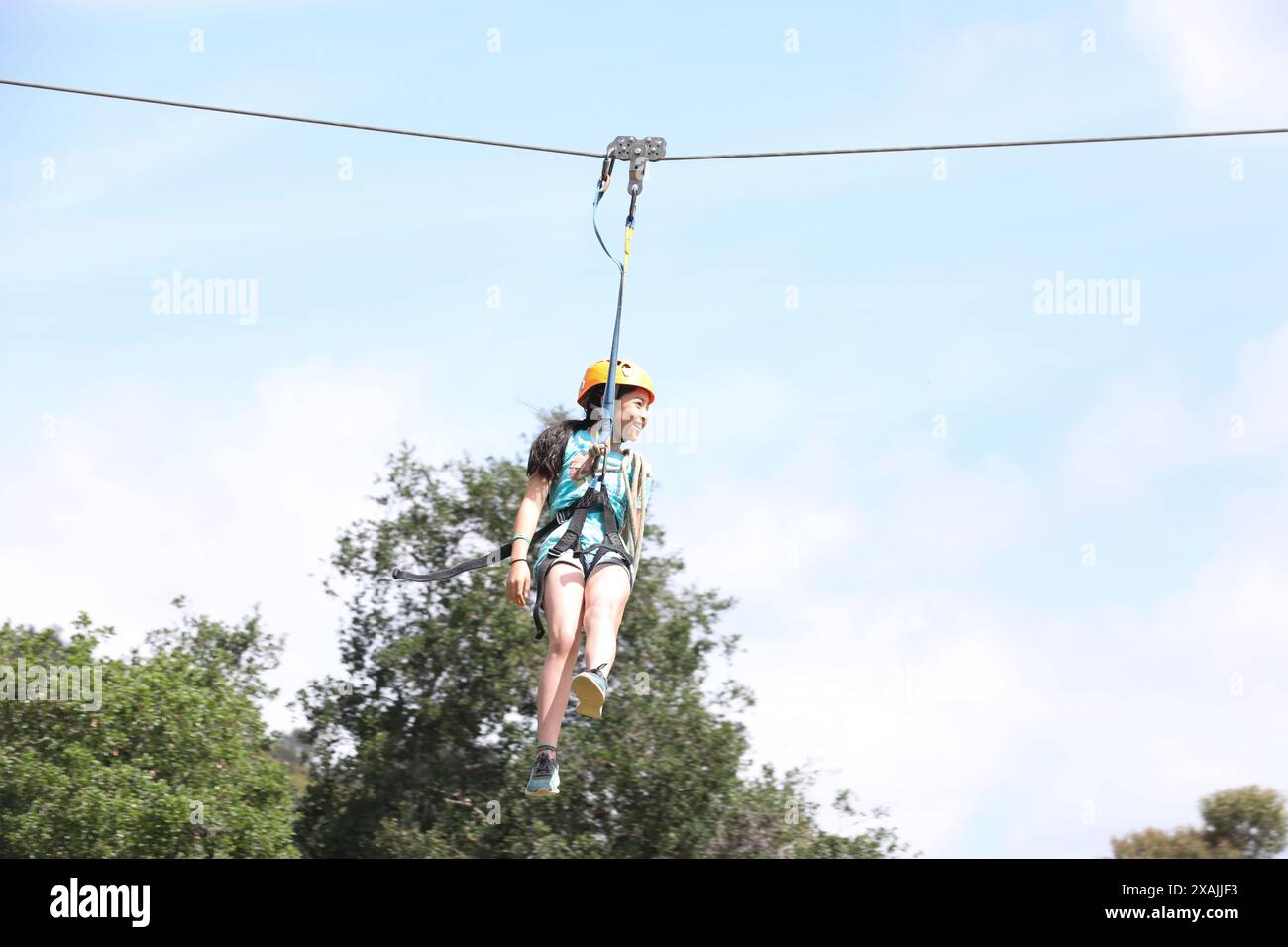Teen's peaceful zip line fun in summer sun in Ojai, California Stock ...