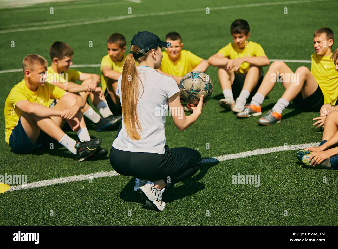 Outdoor Sports Training. Kids in sports gear sitting on outdoor soccer ...