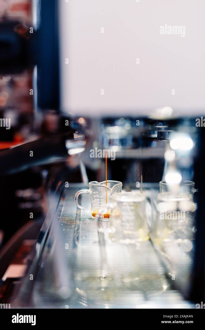 Rich espresso flows into a glass, captured mid-pour Stock Photo - Alamy