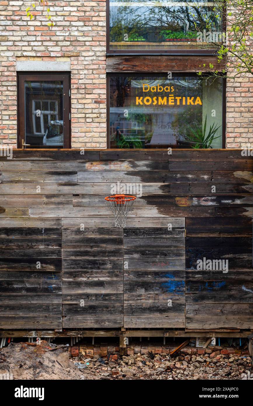 Orange basketball hoop hanging in a construction pit, behind it a ...