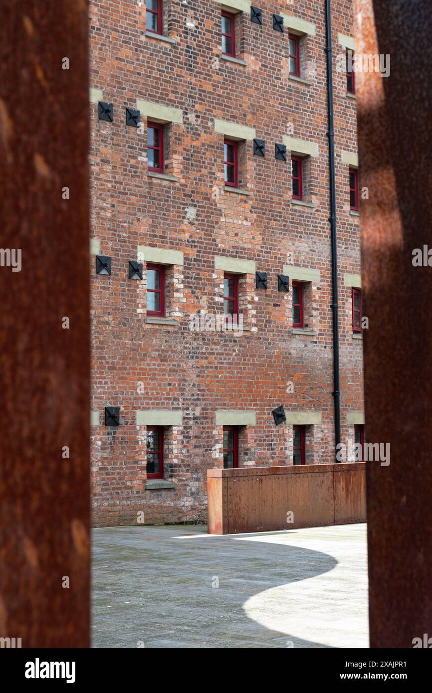 Pattern of brickwork, apartment windows and structural supports in a ...
