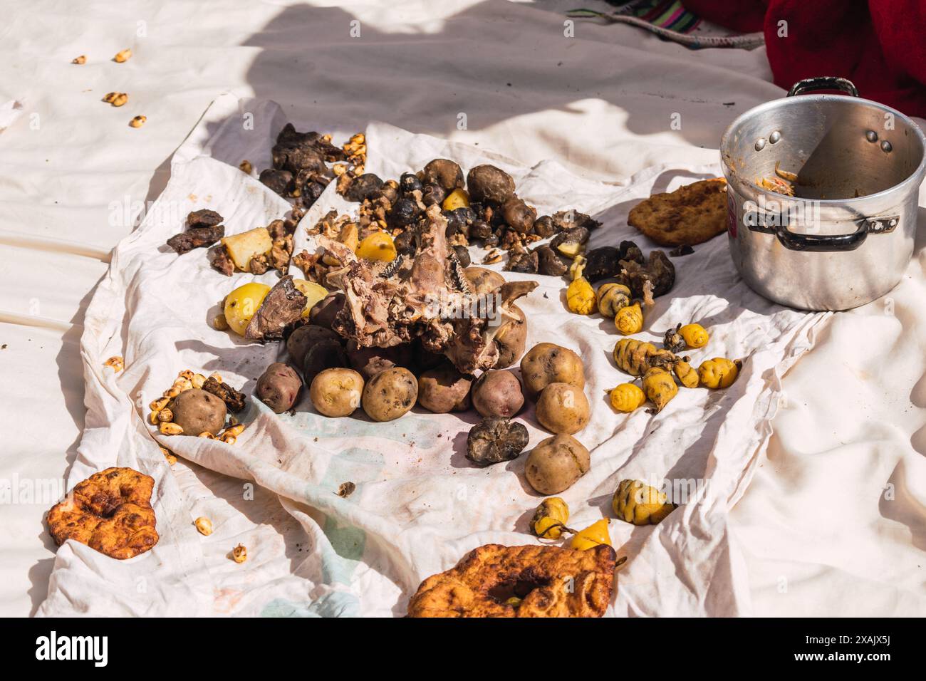 Andean food, spread out on white tablecloths, includes papa chuño in ...