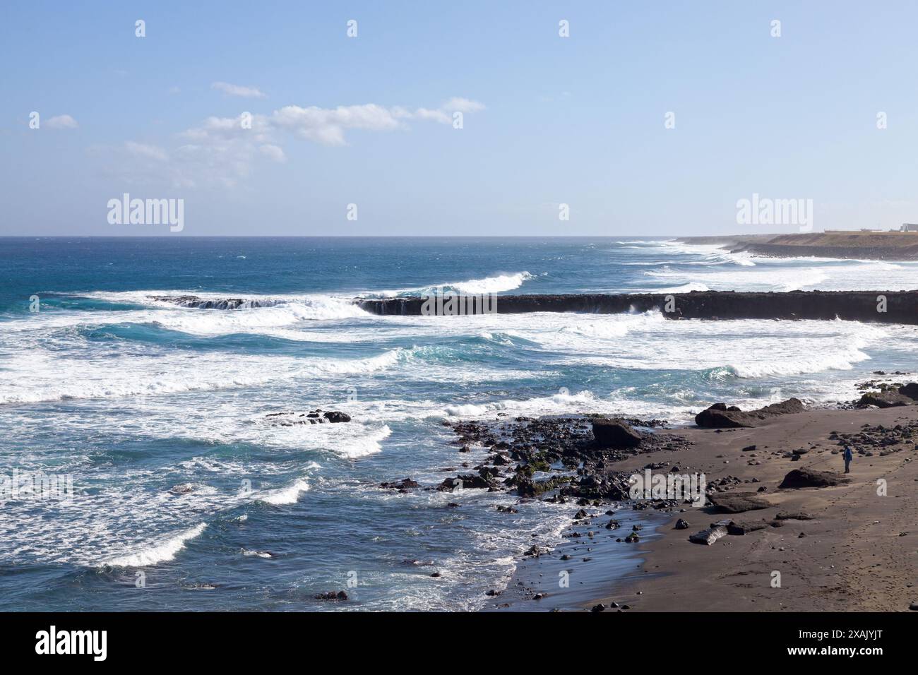 Fisher at the beach by the devil's tip (La pointe du diable), a narrow ...