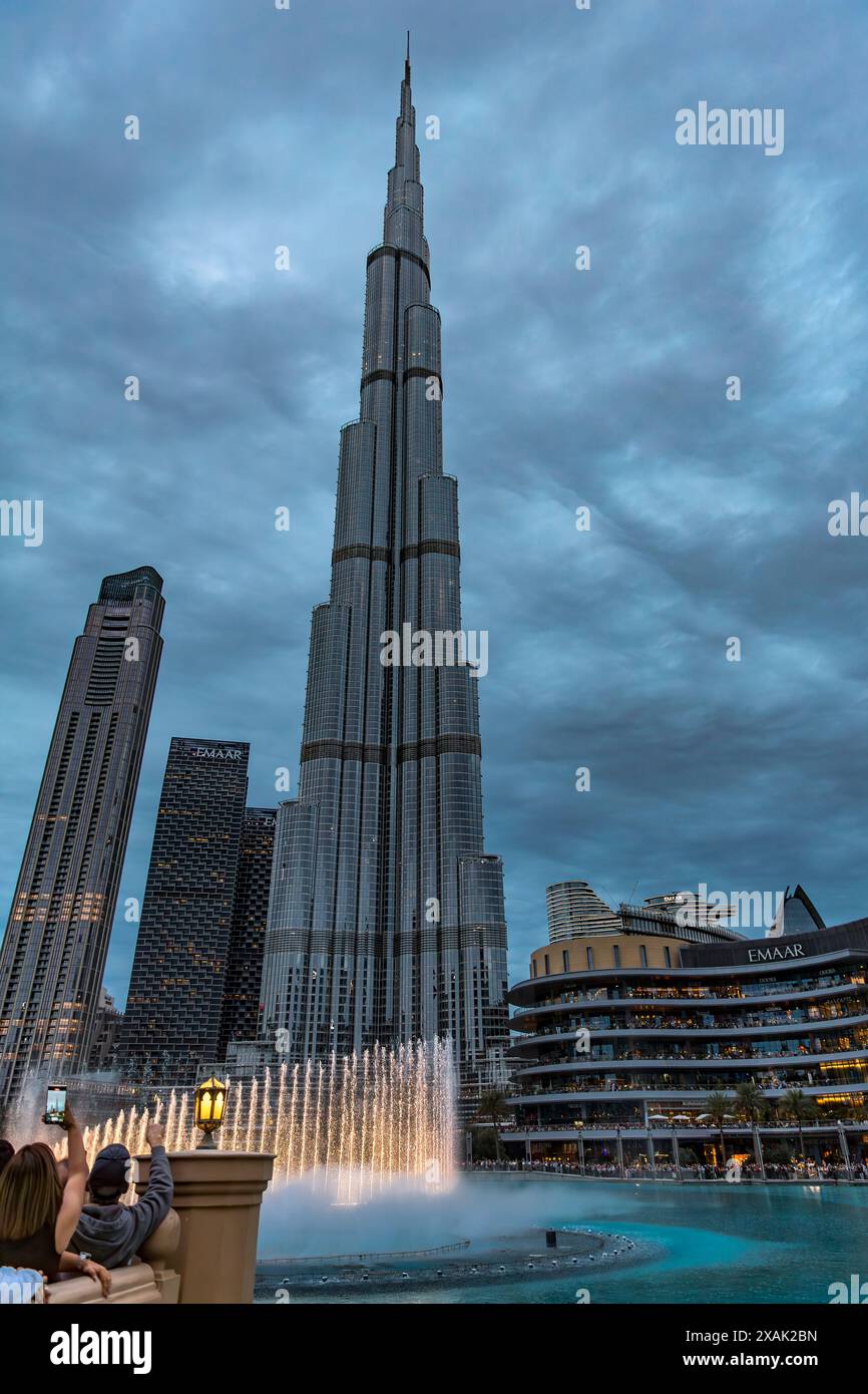 Tourists photograph the water features with light and music, Dubai ...