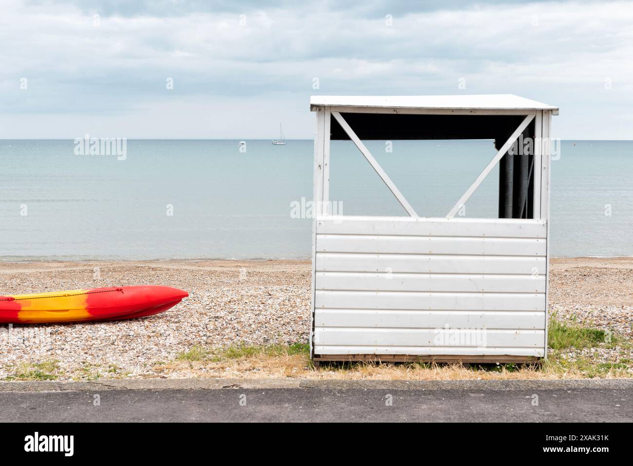 View of the beach with kayak on the left and beach hut on the right ...
