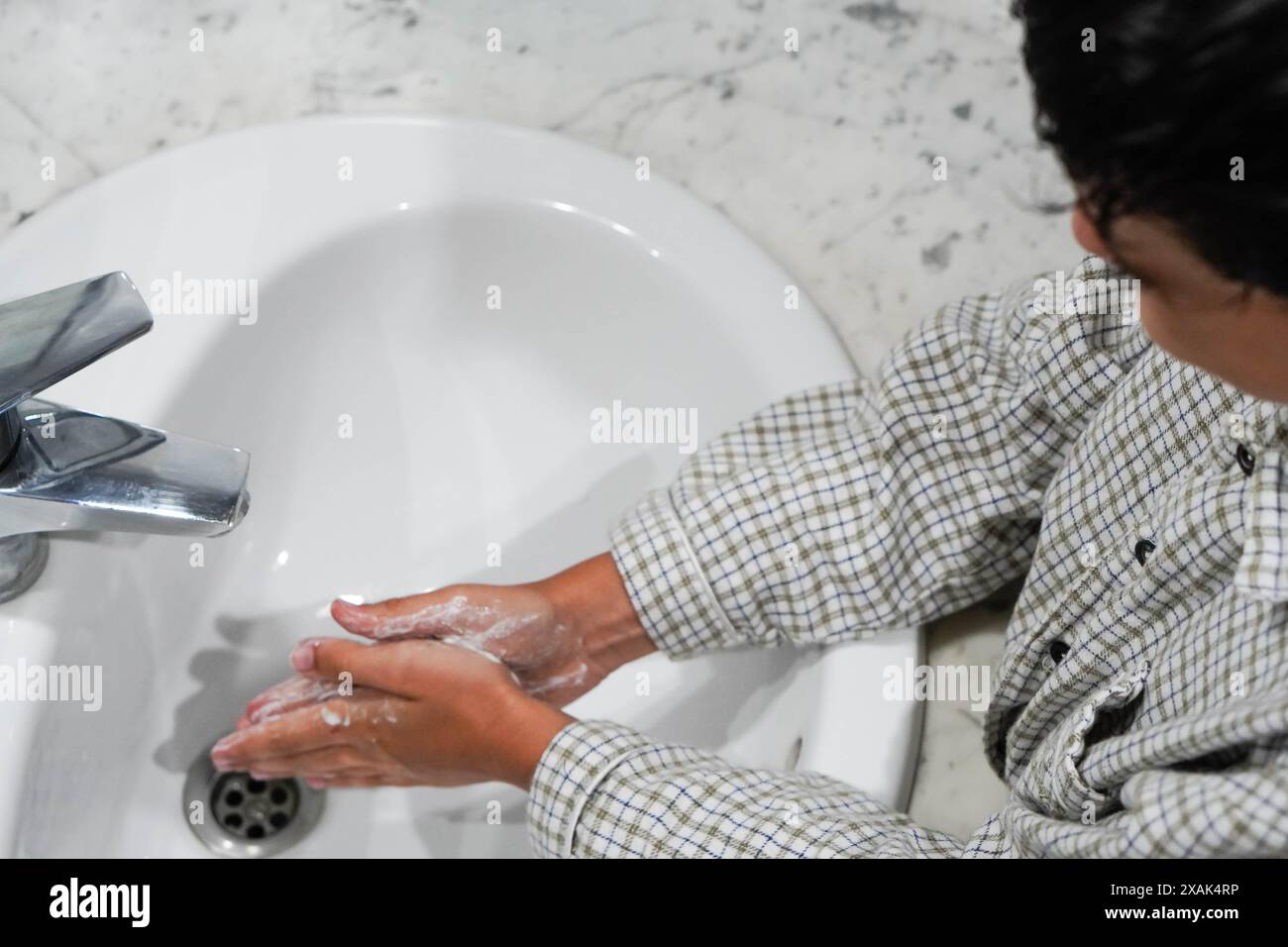 morning routine. child in pyjamas washing hands Stock Photo - Alamy