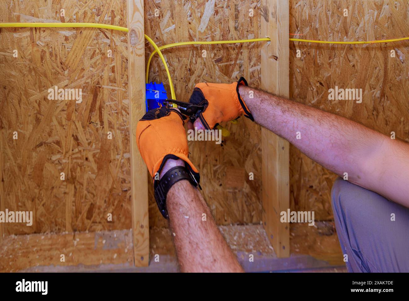 On residential construction site, an electrician installs assembled ...
