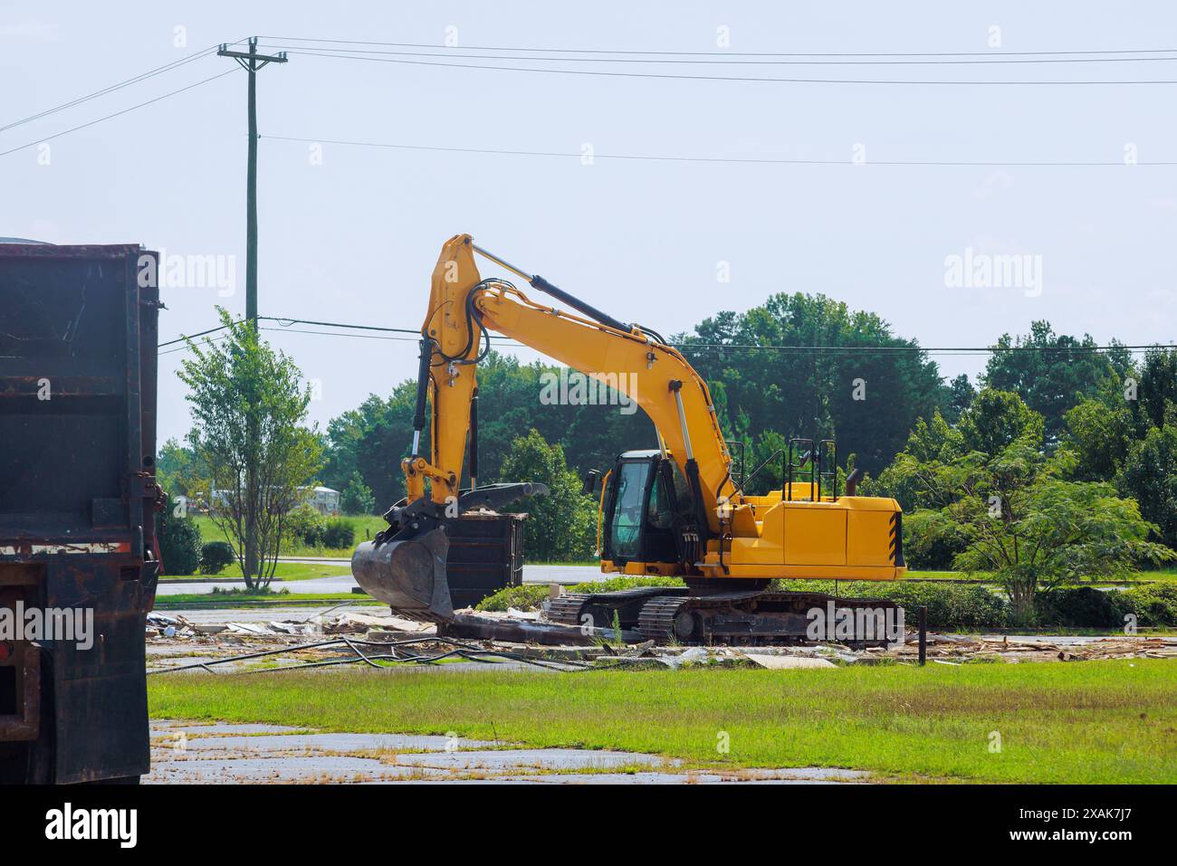 Construction excavator loads construction concrete waste into dump ...