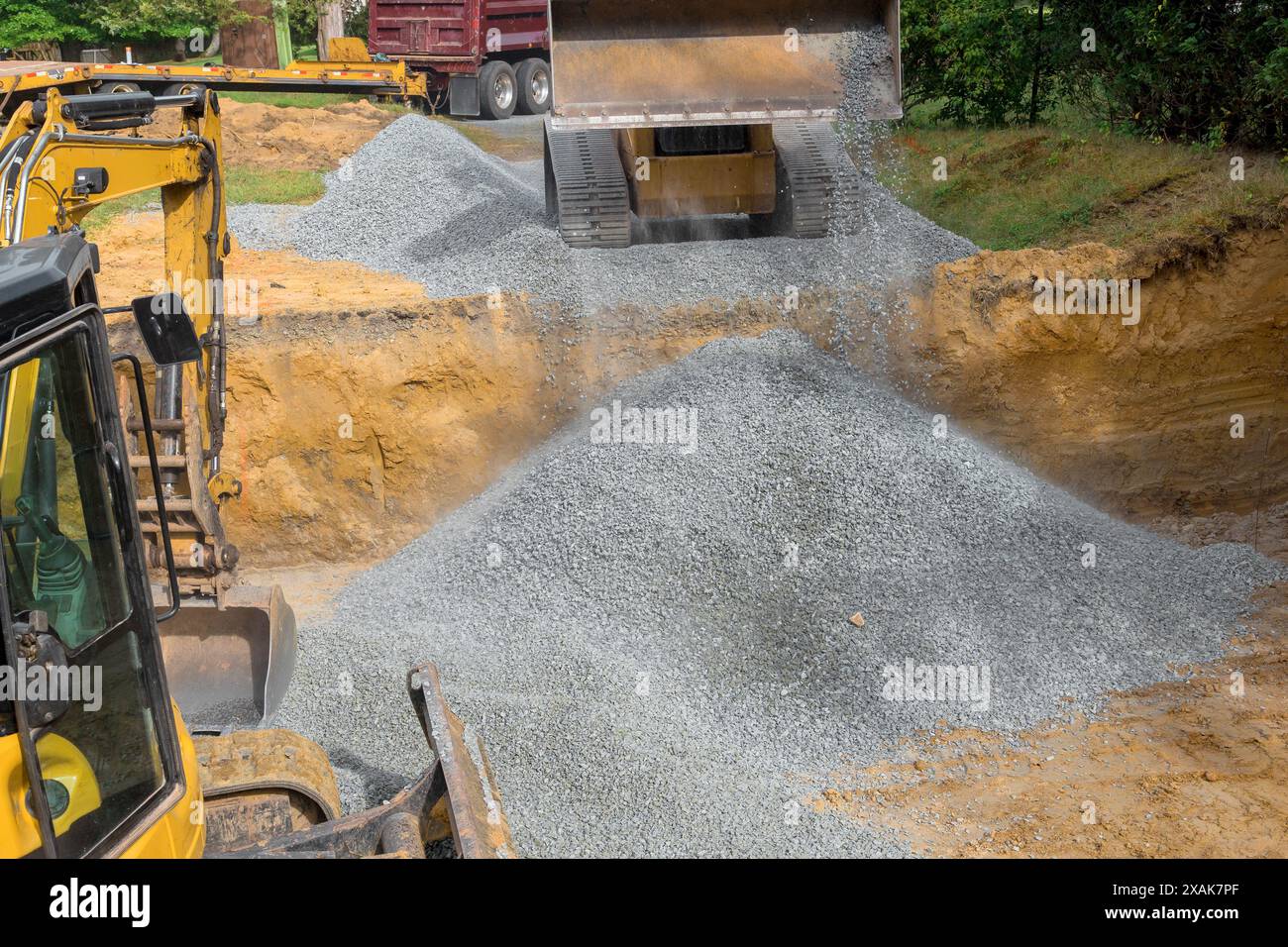 Construction site irregularities are filled with granite rubble base ...
