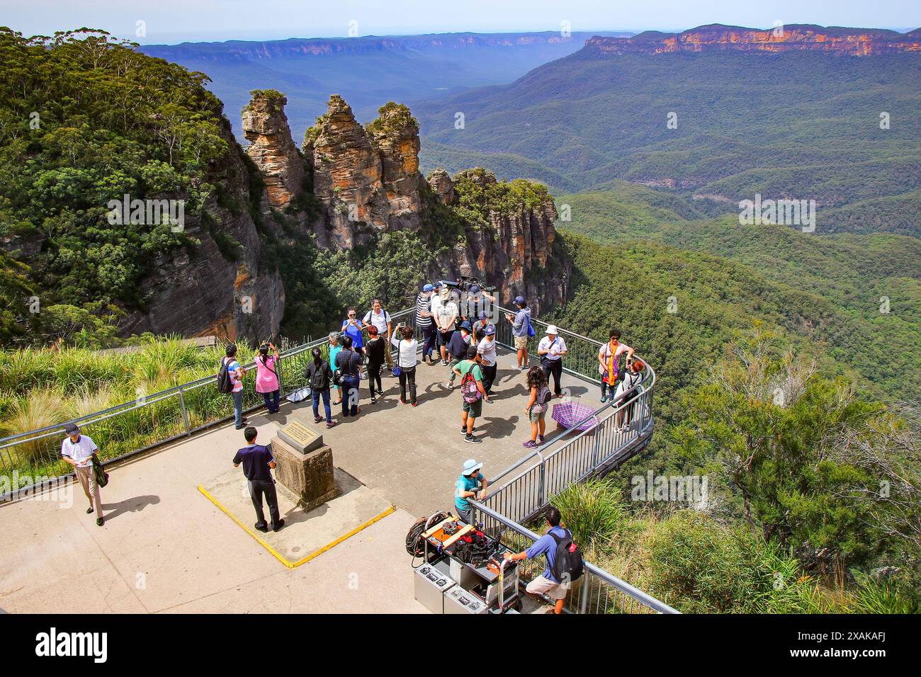 Tourists and film crew on the Echo Point lookout, taking pictures of ...