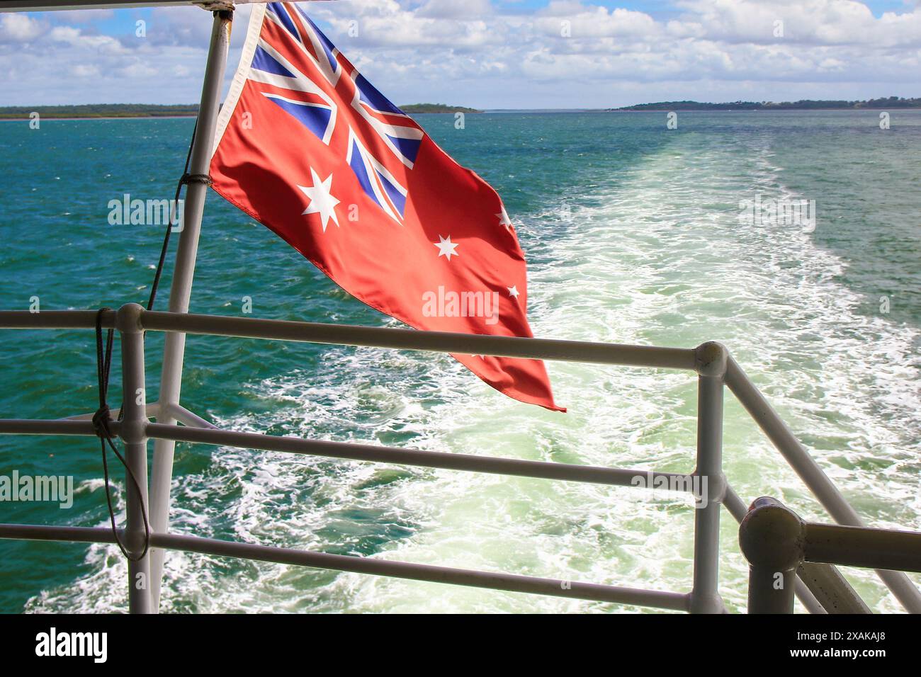 Australian Red Ensign flag on the aft of the Kingfisher Bay ferry ...