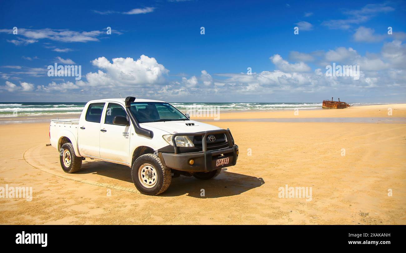 4WD trucks driving offroad on the Fraser island beach track near the SS ...
