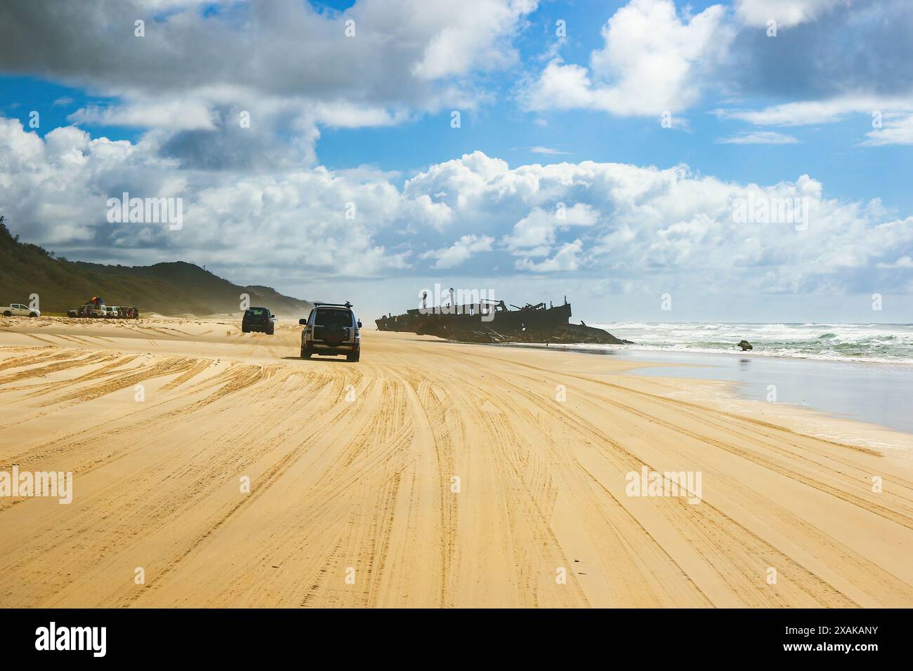 4WD trucks driving offroad on the Fraser island beach track near the SS ...