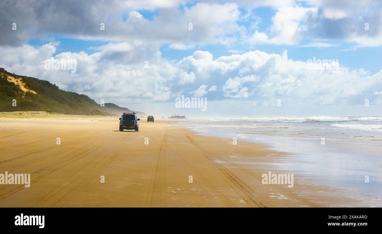 4WD trucks driving offroad on the Fraser island beach track near the SS ...