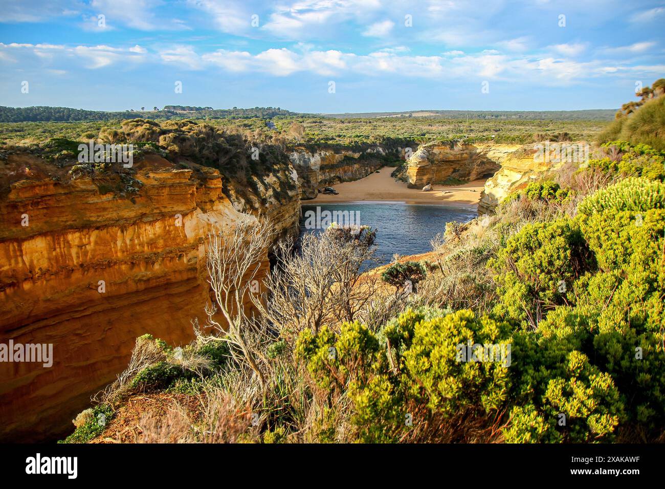 Beach in Loch Ard Gorge surrounded by sandstone cliffs at the Twelve ...