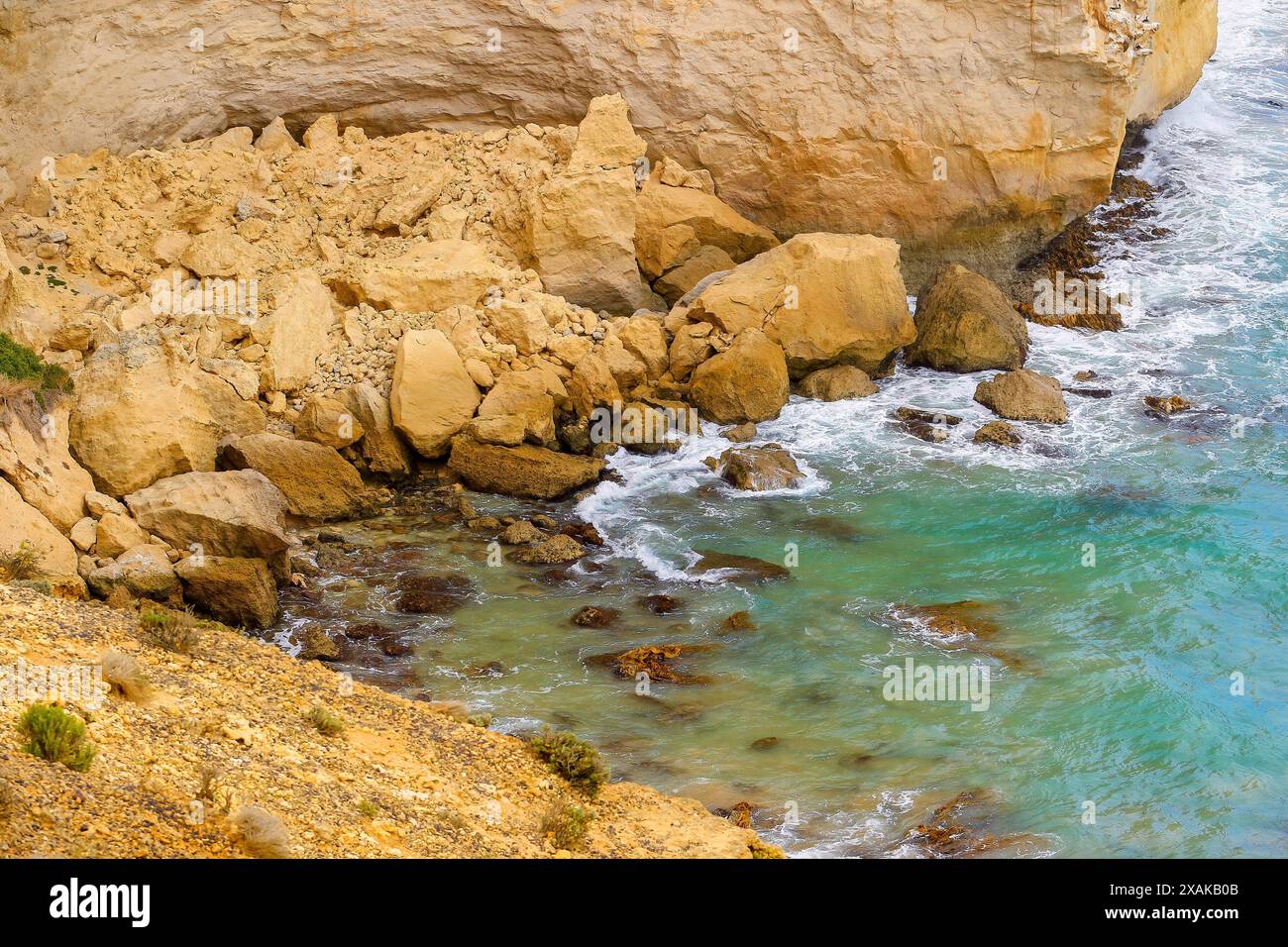 Collapsed rubble at the bottom of a cliff of the Twelve Apostles, a ...