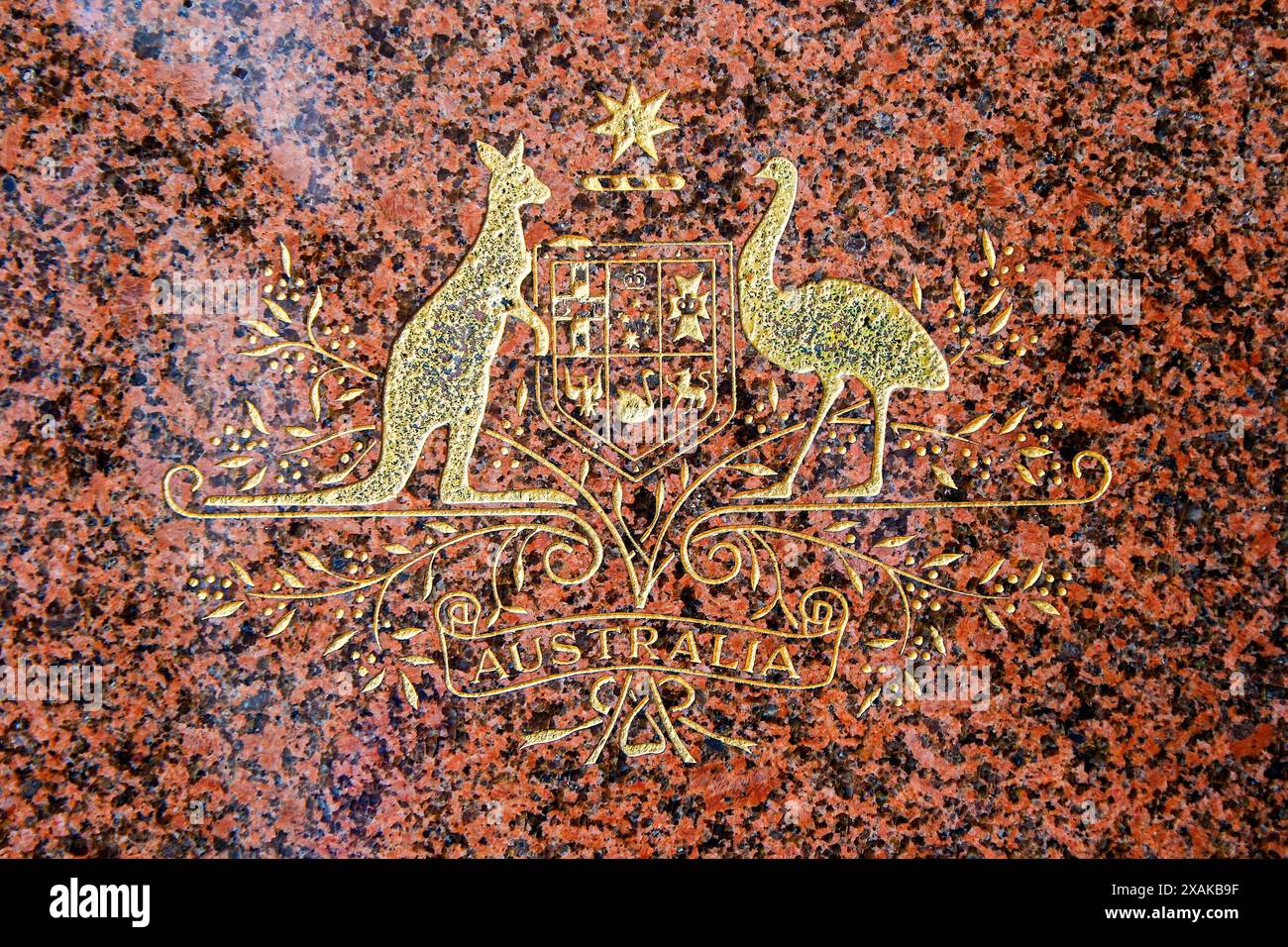 Golden coat of arms of Australia featuring a shield held by a kangaroo ...