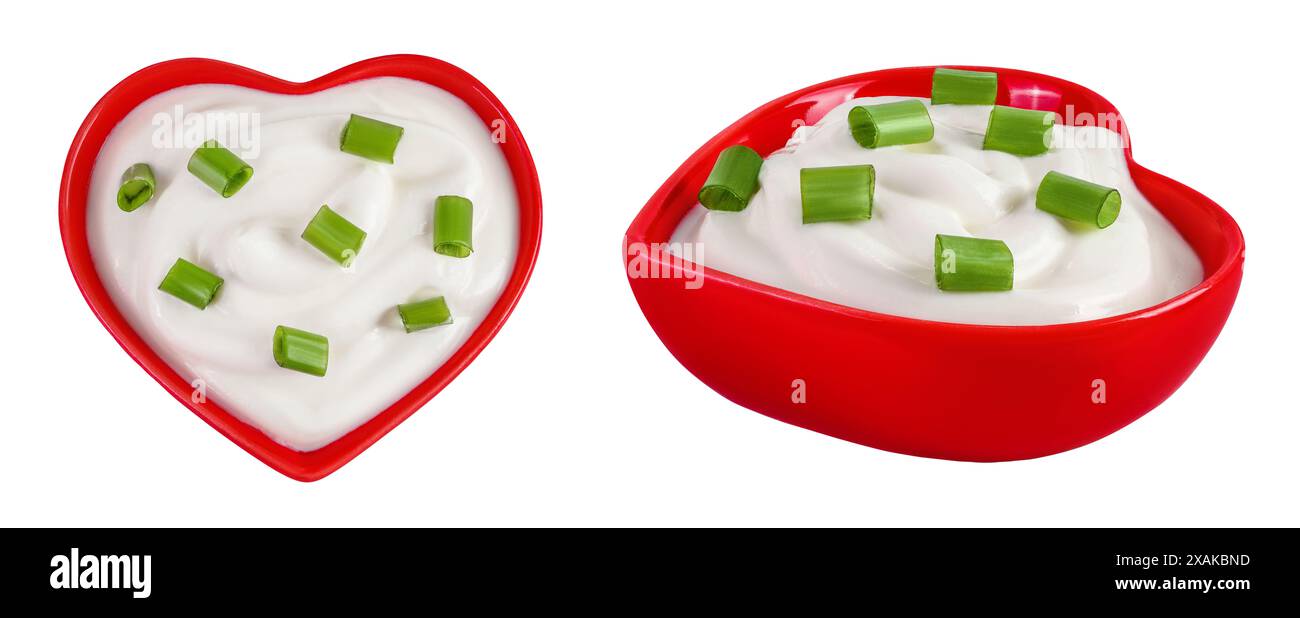 sour cream or yogurt in red ceramic bowl heart shaped isolated on white ...