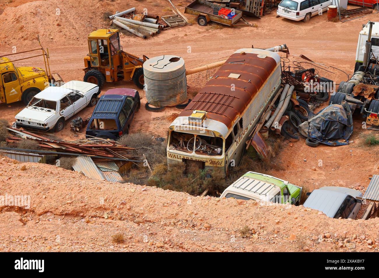 Old bus in a junkyard of rusty abandoned vintage cars in the desert of ...