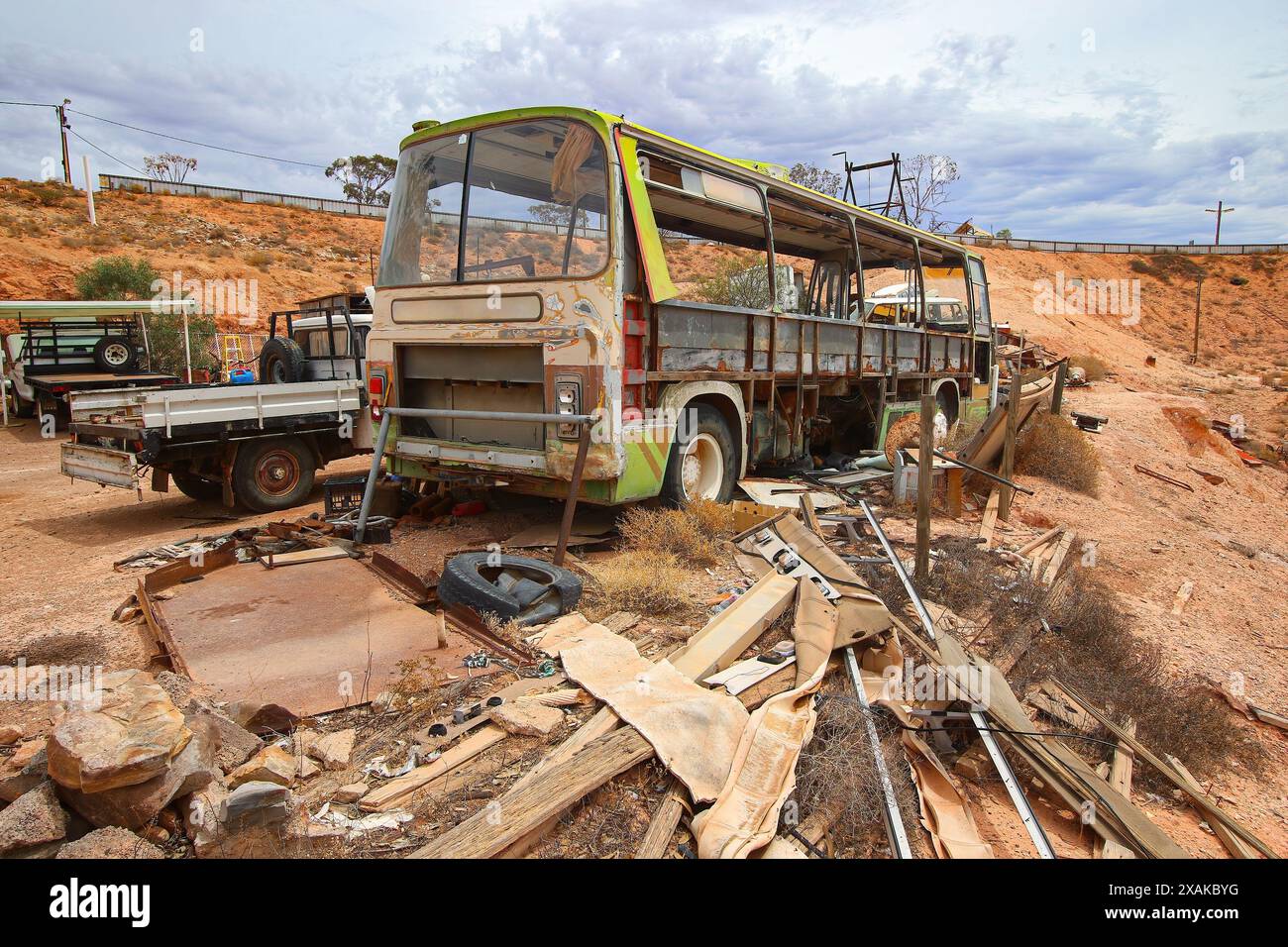 Old bus in a junkyard of rusty abandoned vintage cars in the desert of ...