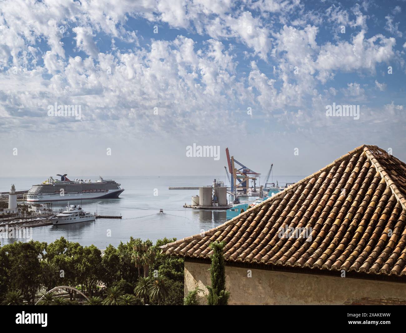 The harbor of Malaga, with a cruise ship and the La Farola lighthouse ...