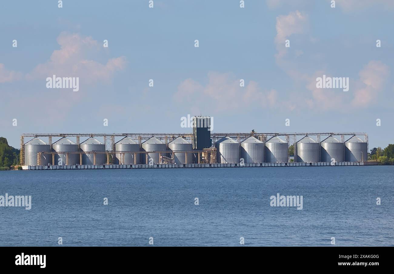 A grain elevator storage facility on a river, summer day Stock Photo ...
