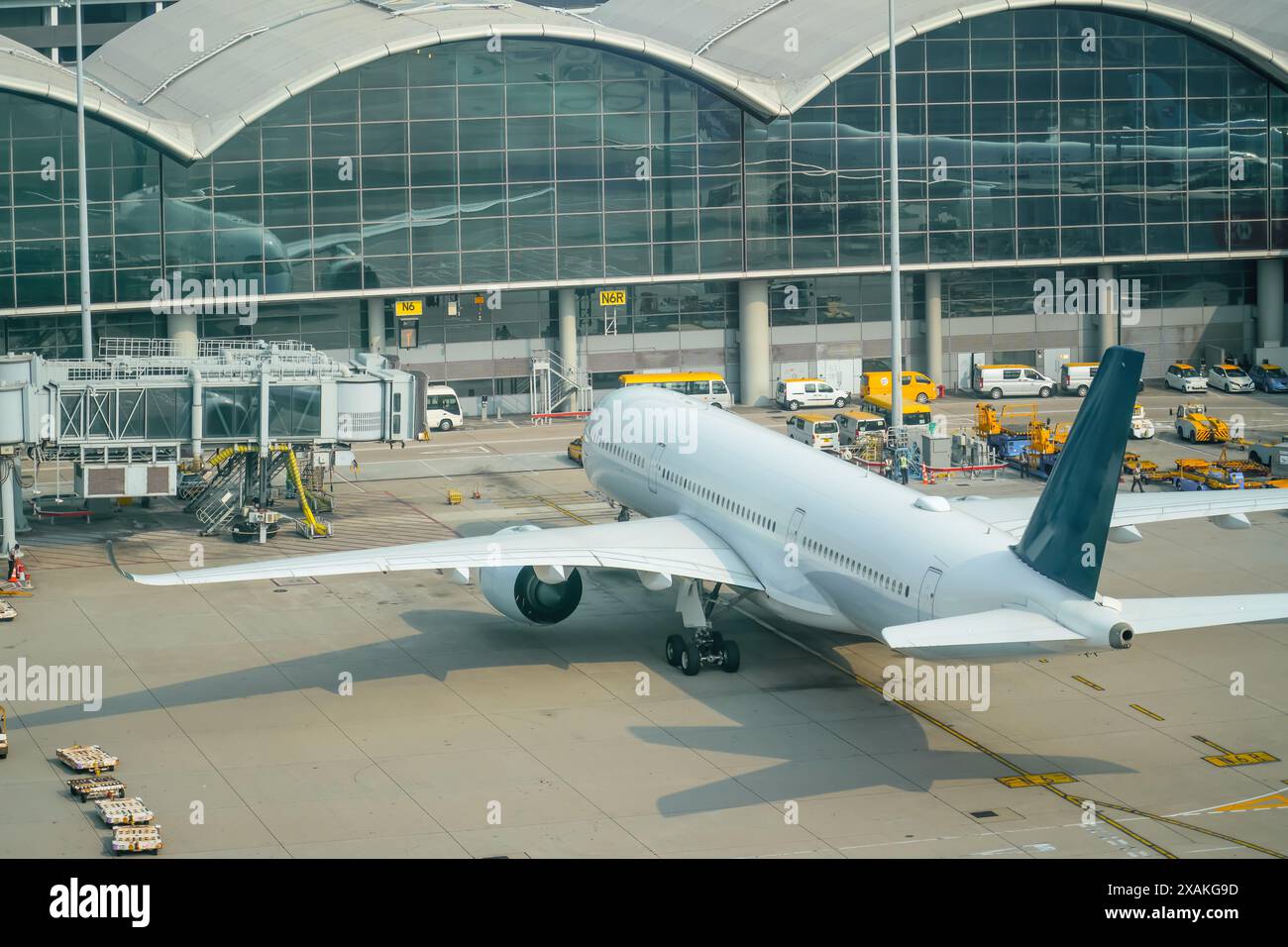 Airport building and passenger jet aircraft servicing flight bridge ...