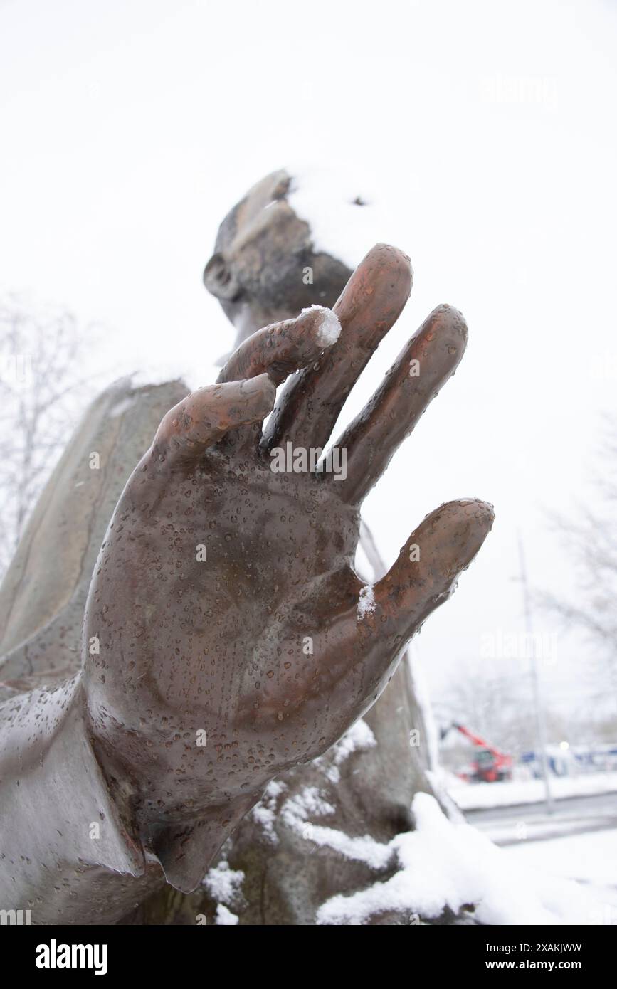 Snow-covered statue of the Latvian writer Rainis in front of the ...