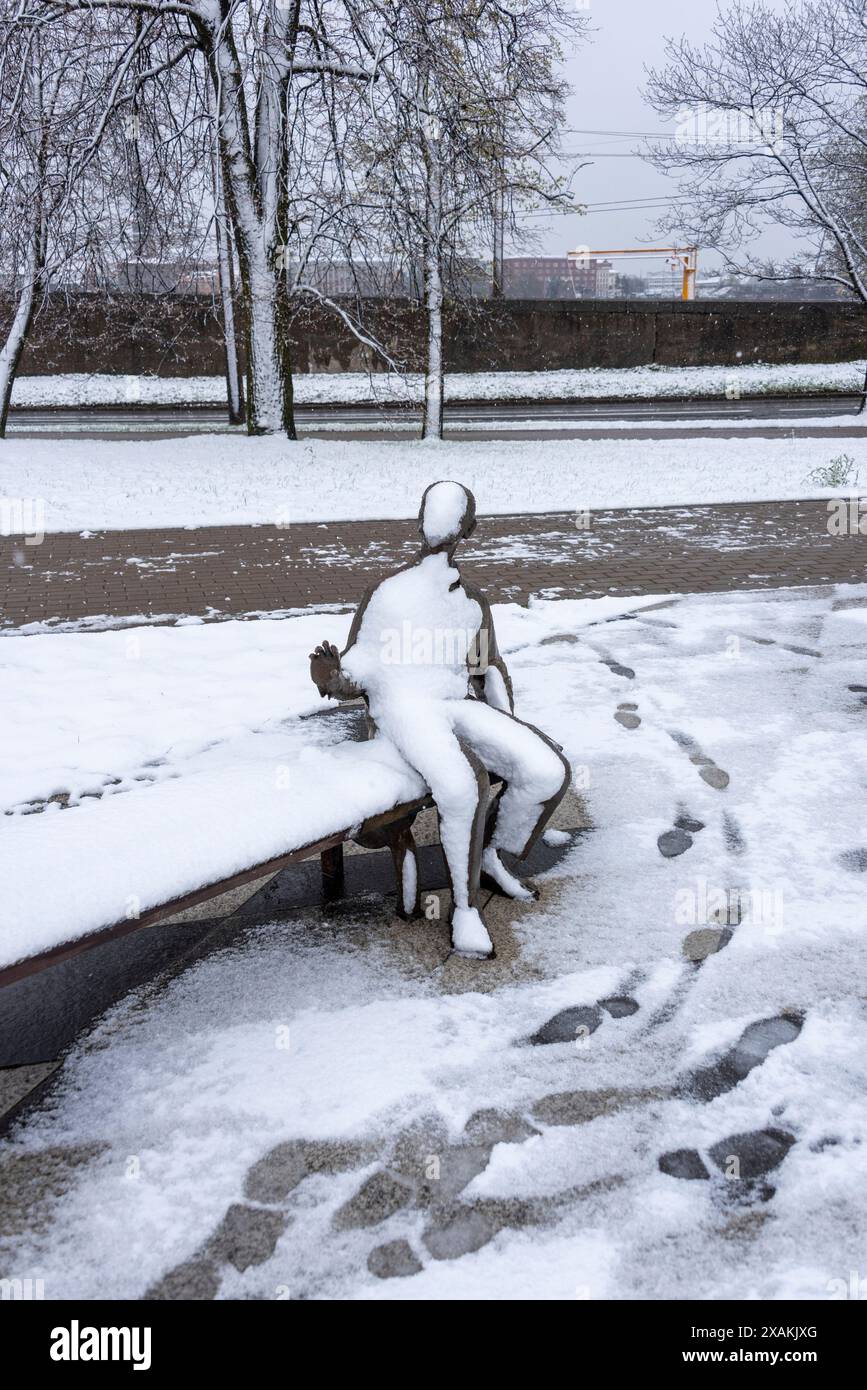Snow-covered statue of the Latvian writer Rainis in front of the ...