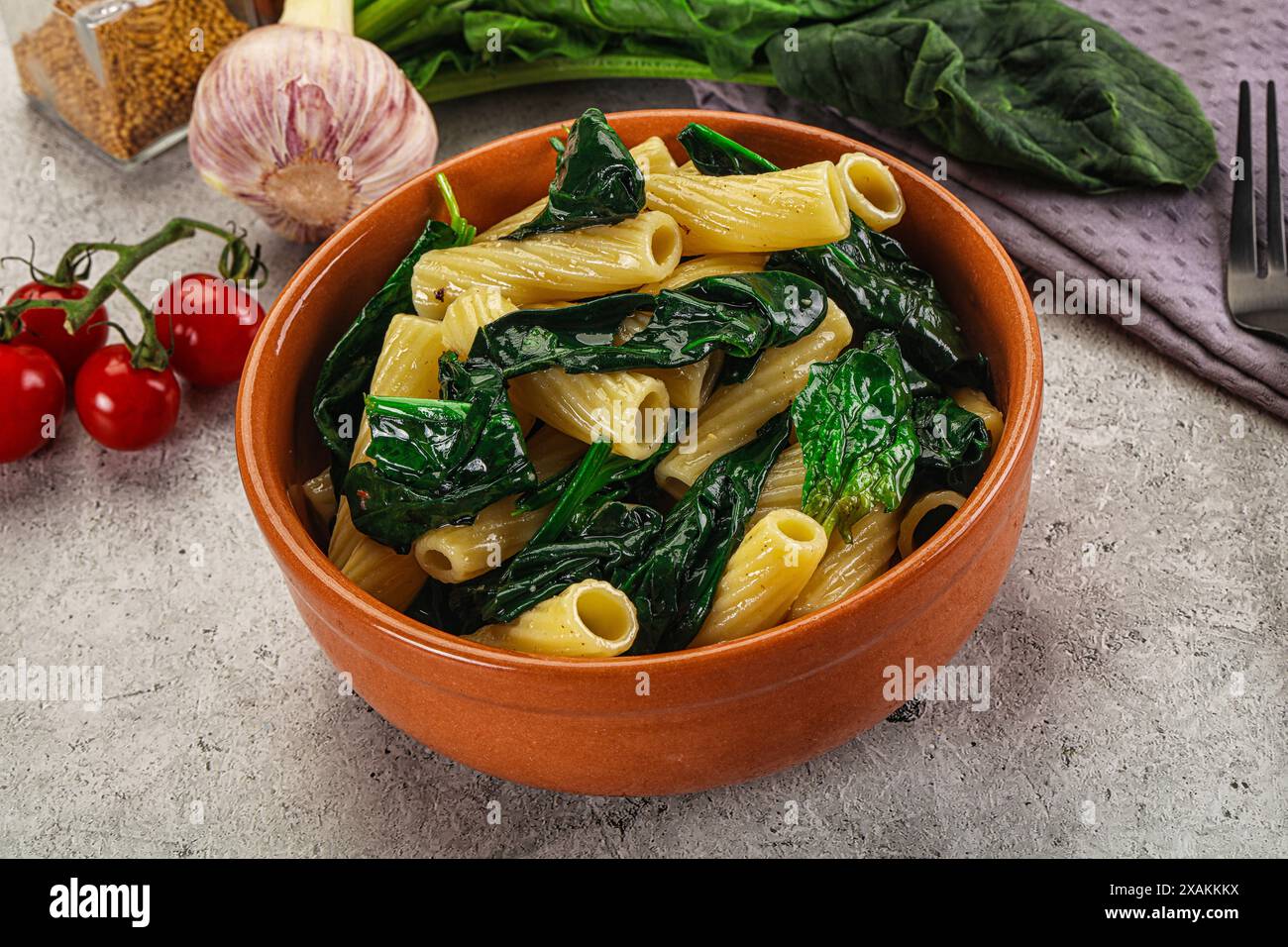 Italian cuisine - pasta tortiglioni with spinach Stock Photo - Alamy