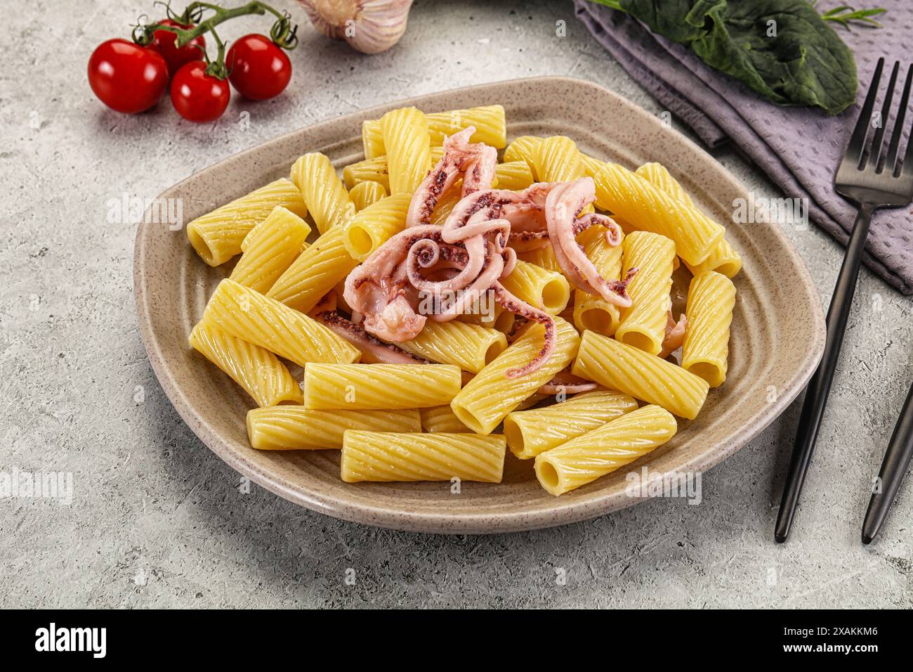 Italian cuisine - pasta tortiglioni with squid tentacles Stock Photo ...