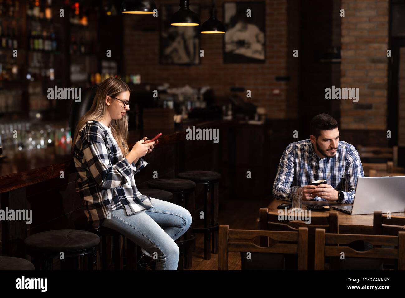 Two young people, husband and wife, Pub owners, working in their ...