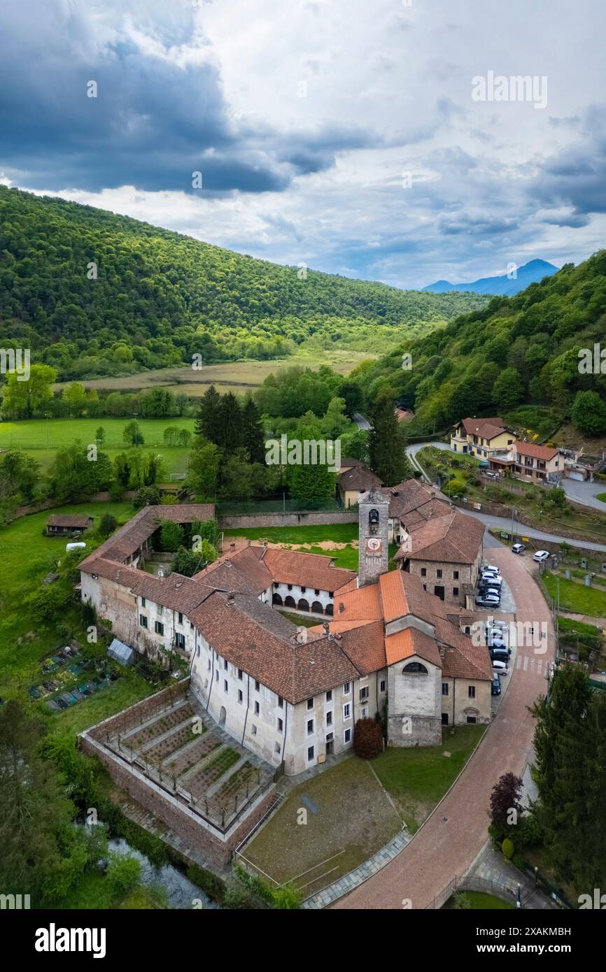 Aerial view of the ancient Badia di San Gemolo in Ganna on a spring day ...